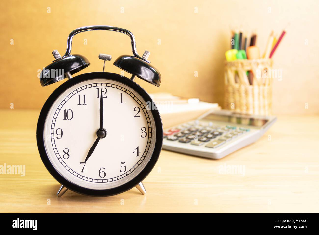 7 AM Clock on work desk in the office Time of business working concepts ...