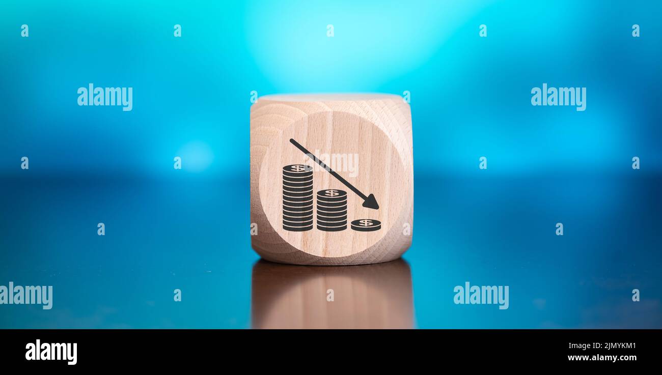 Wooden block with symbol of economic crash concept on blue background ...