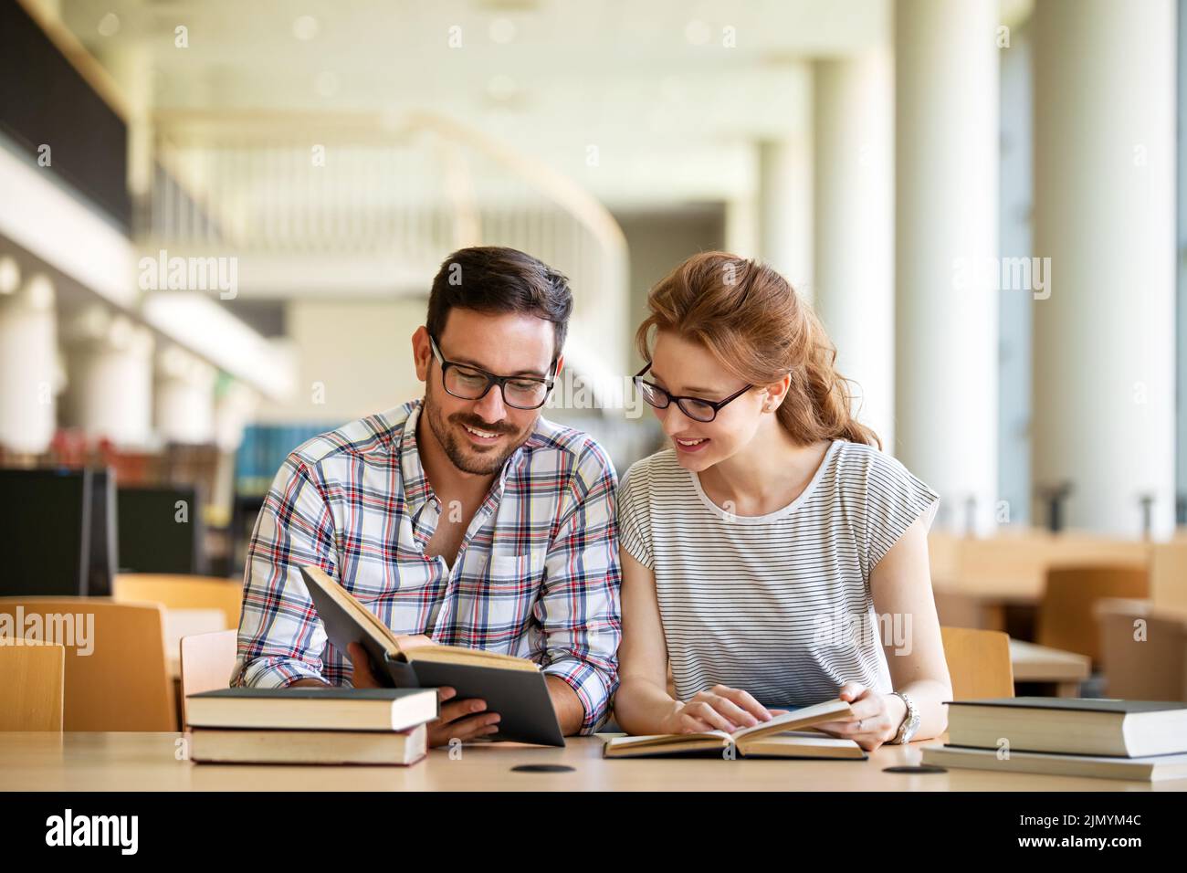 Happy group of students studying and working together in a college ...