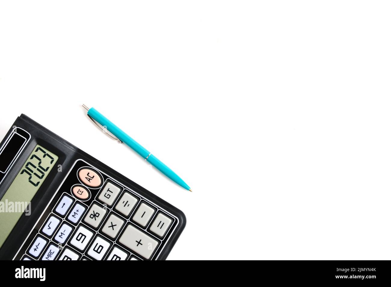 Calculator turned off and a ballpoint pen on white background Stock ...