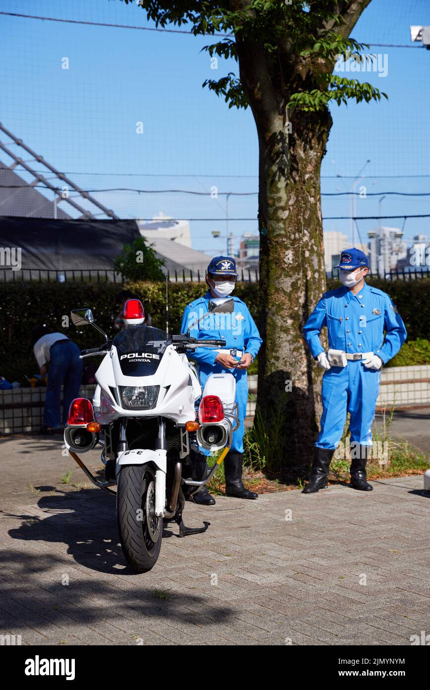 Japanese police men standing next to police motorcycle; Japan Stock ...