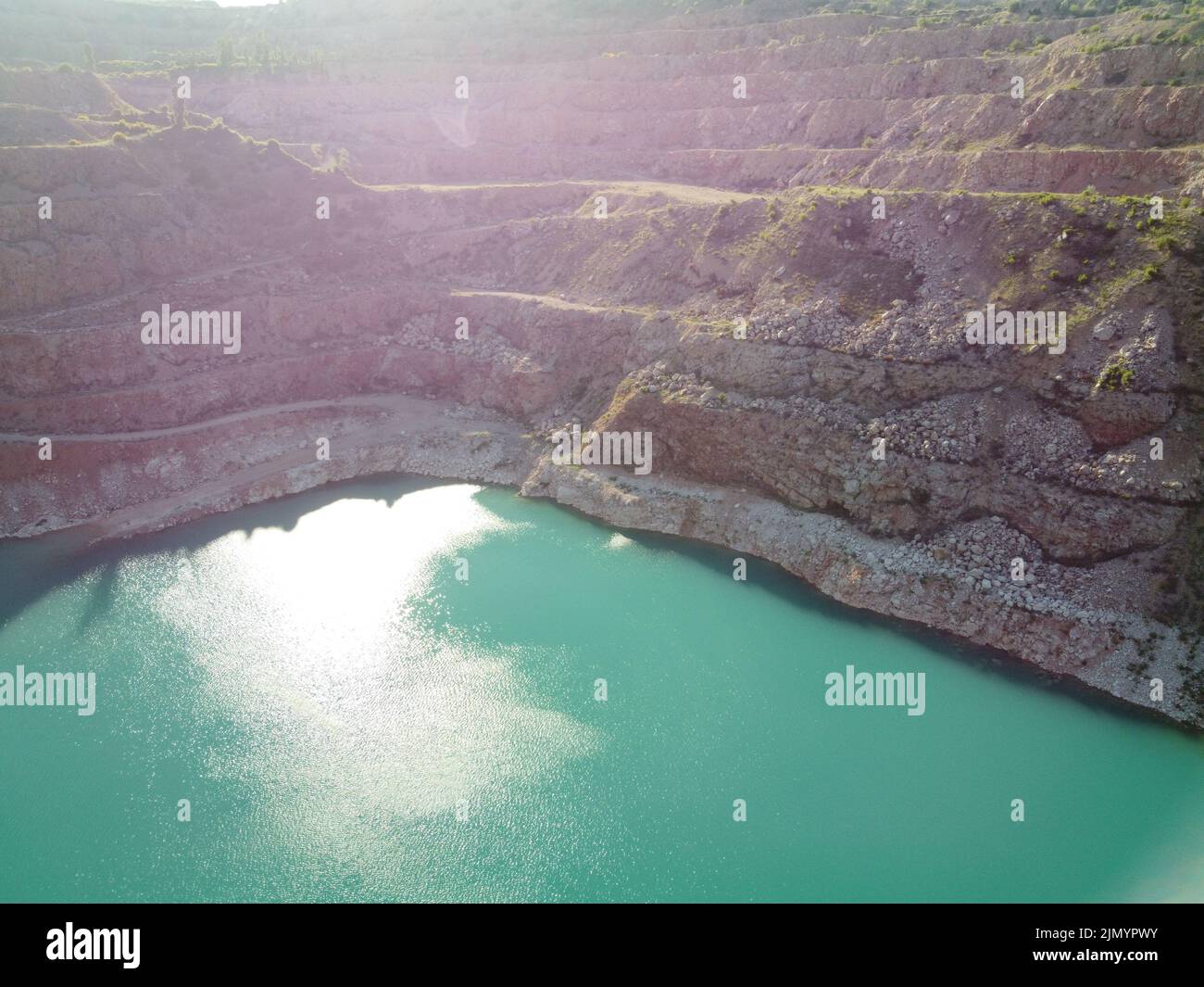 Aerial top view on opencast mining quarry with flooded bottom ...