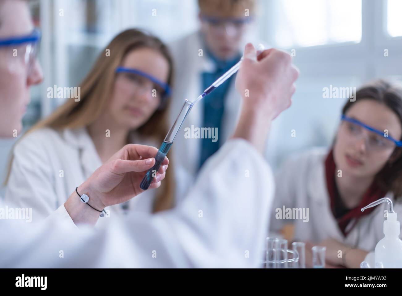 Science students doing chemical experiment in the laboratory at ...