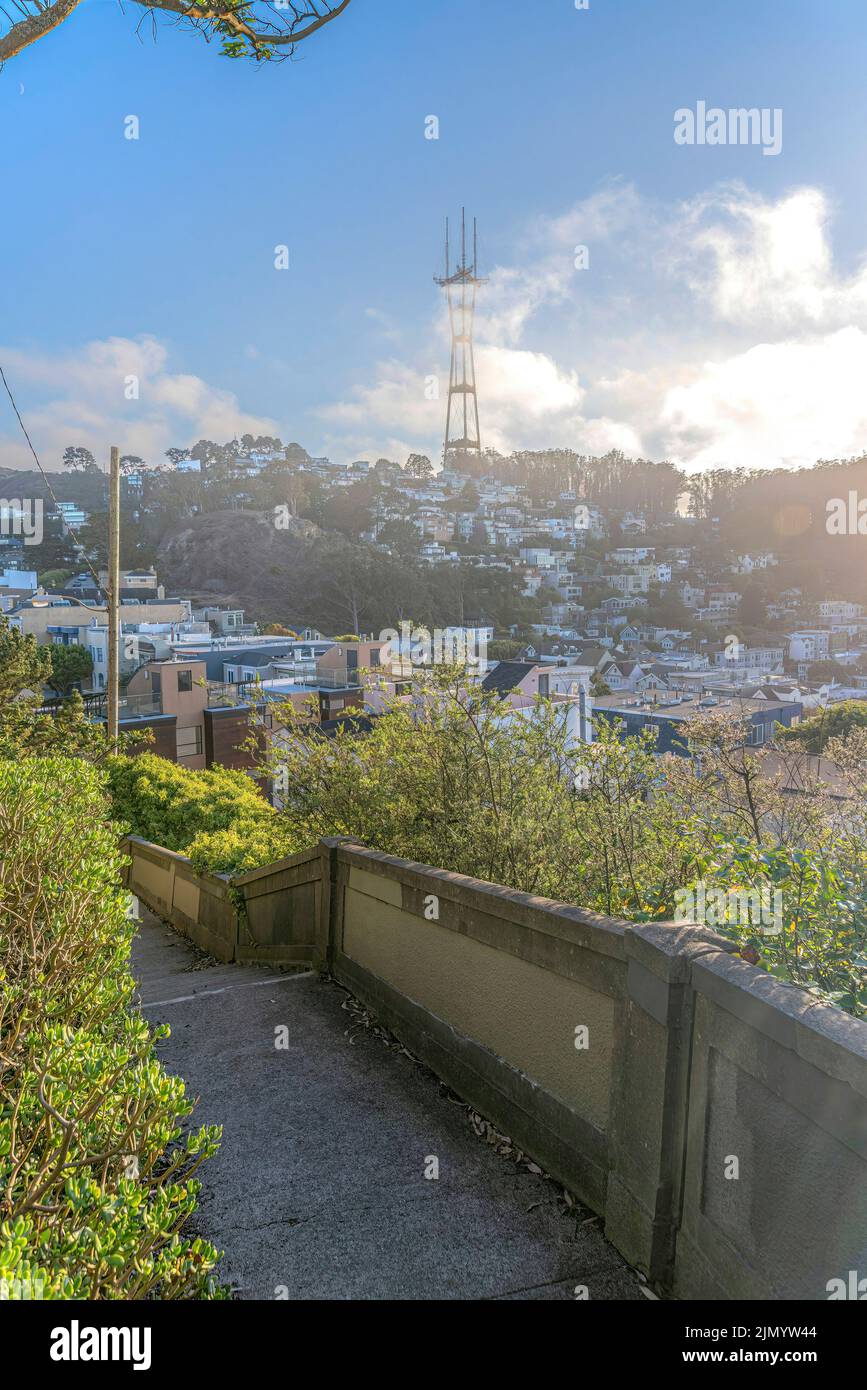 View of Sutro Tower against the clouds from a concrete pathway with ...