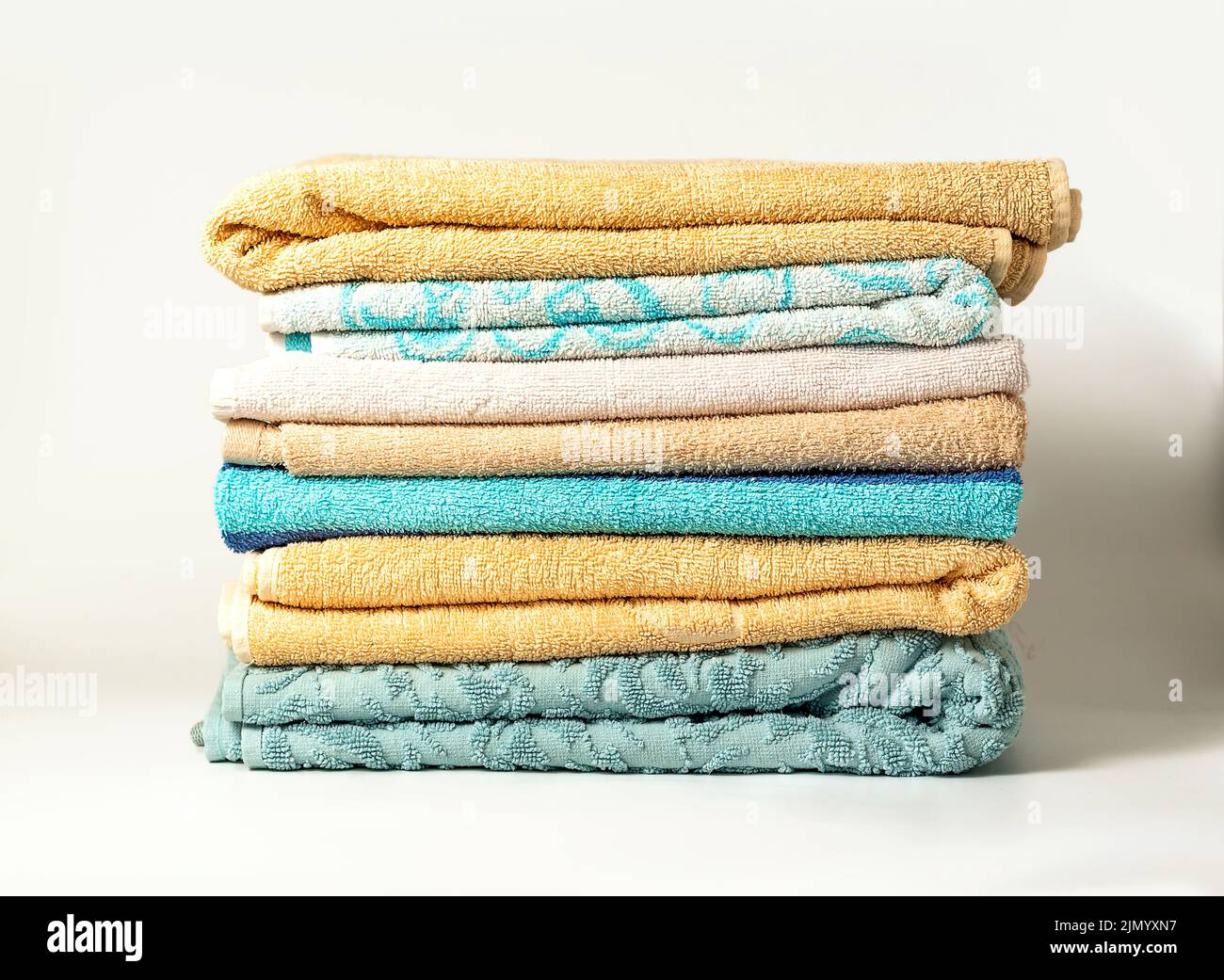 Different colors of towels isolated on white background Stock Photo - Alamy
