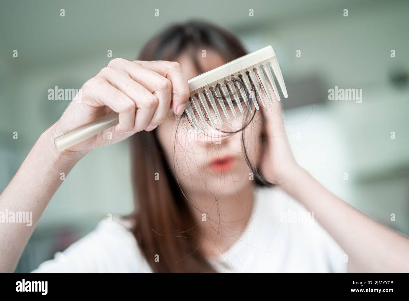 Asian woman have problem with long hair loss attach to comb brush Stock ...
