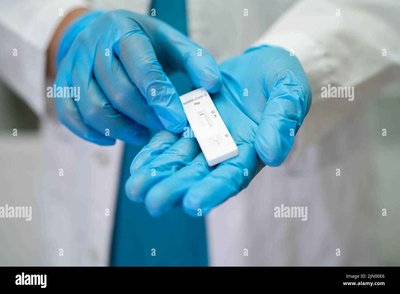 Asian doctor in PPE suit show positive test result with Saliva Antigen ...