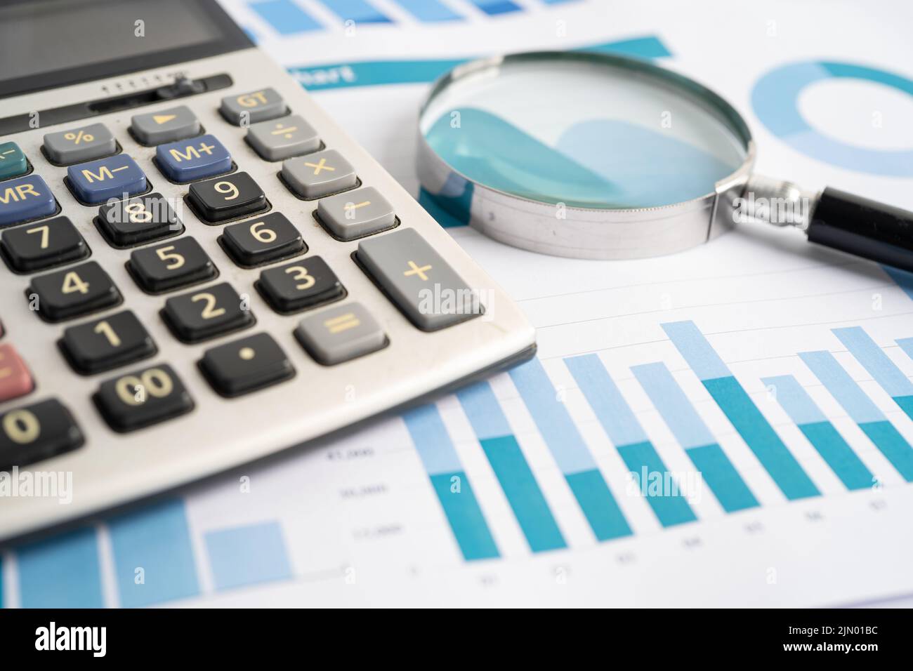 Magnifying glass on charts graphs paper. Financial development, Banking ...