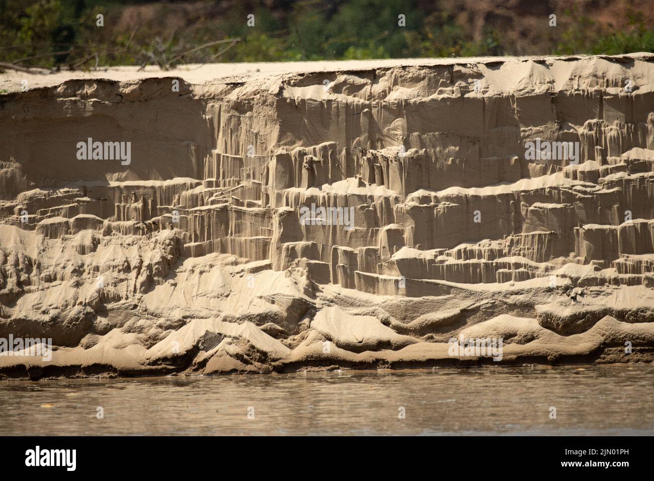 The eroded face of a sandbank in the Rufiji River shows the different ...