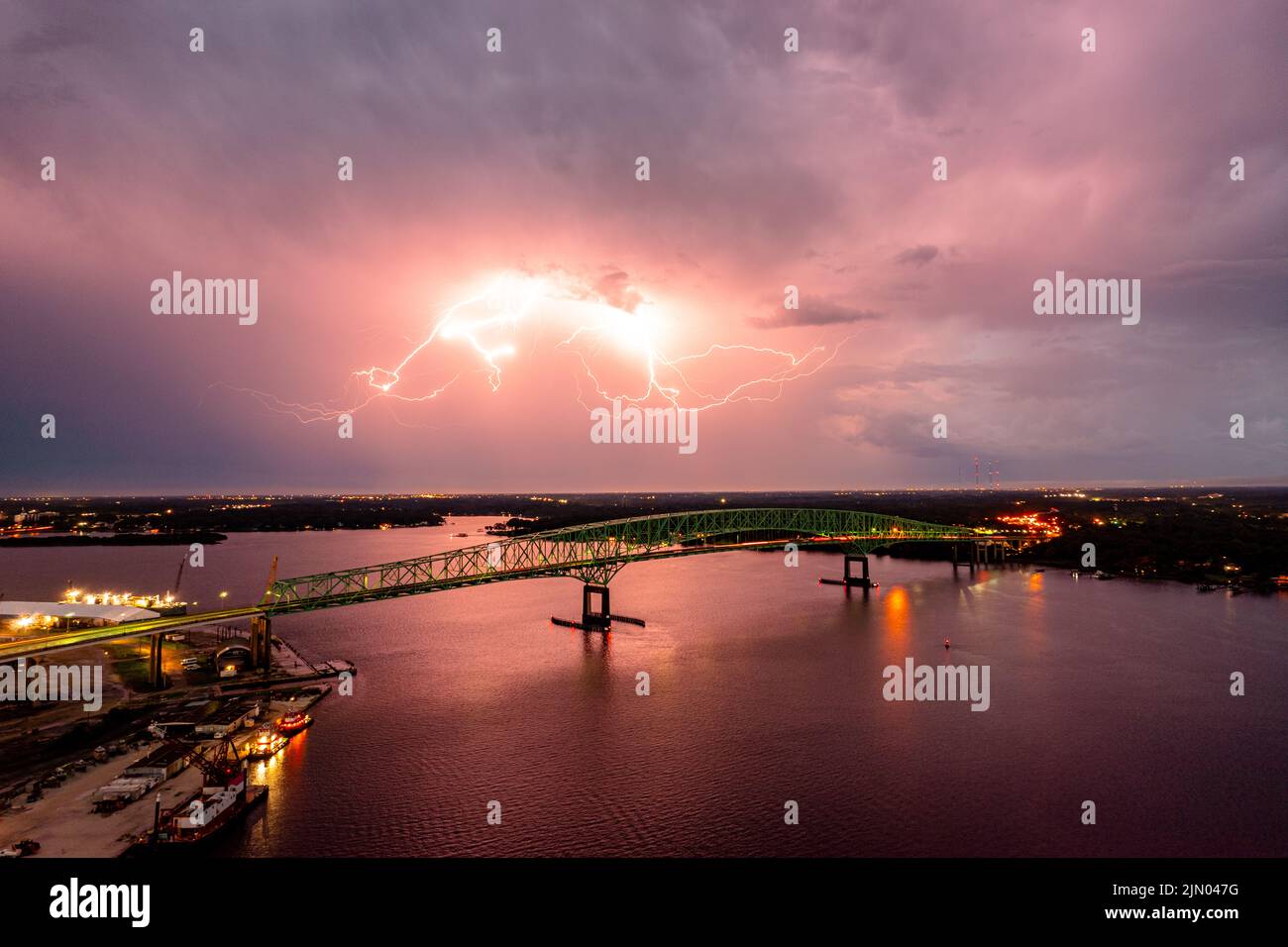 The aerial view of bridge connecting the coasts over the river under ...