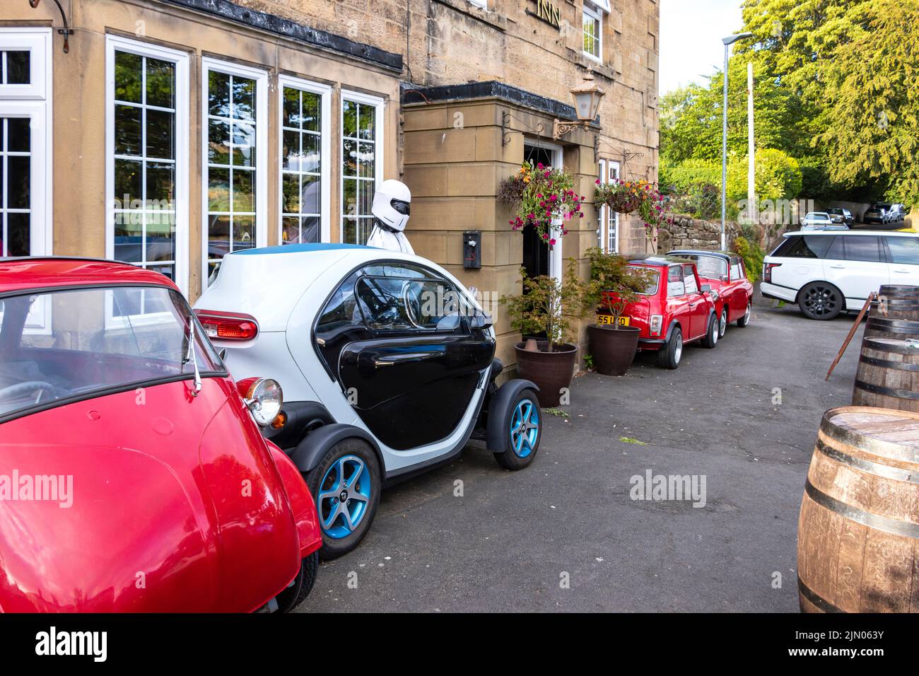 renault twizy and classic red bubble car outside the Crown pub in the ...