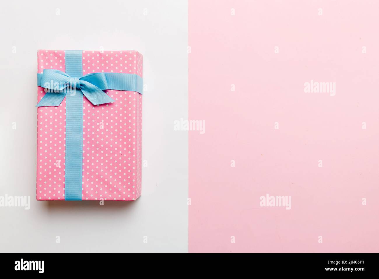 holiday handmade paper present tied blue ribbon bow top view with copy ...