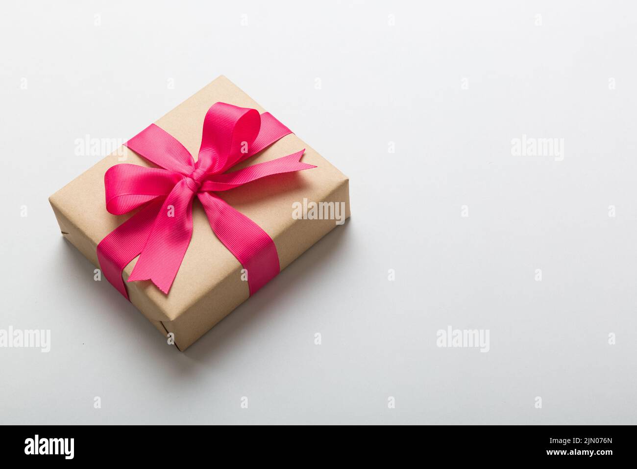 Wrapped christmas or other holiday handmade present in craft paper with ...