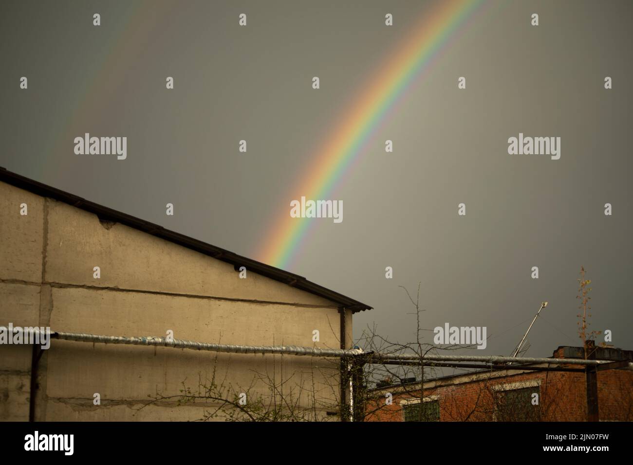 Rainbow in sky. Beautiful weather. Decomposition of light into colors ...