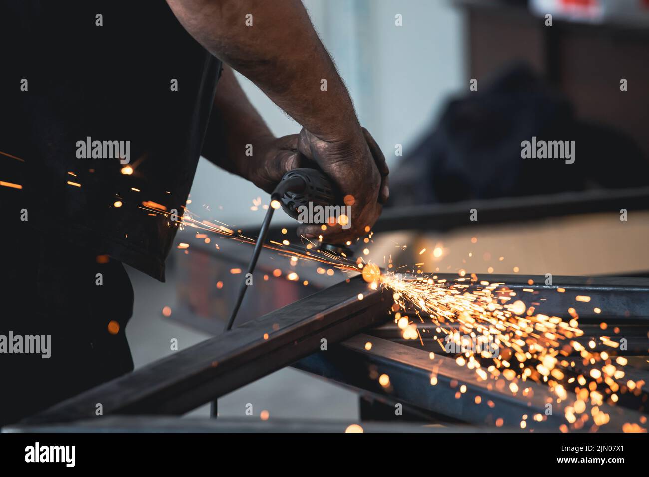 Profesional fabric worker cutting metal profile on the work table with ...