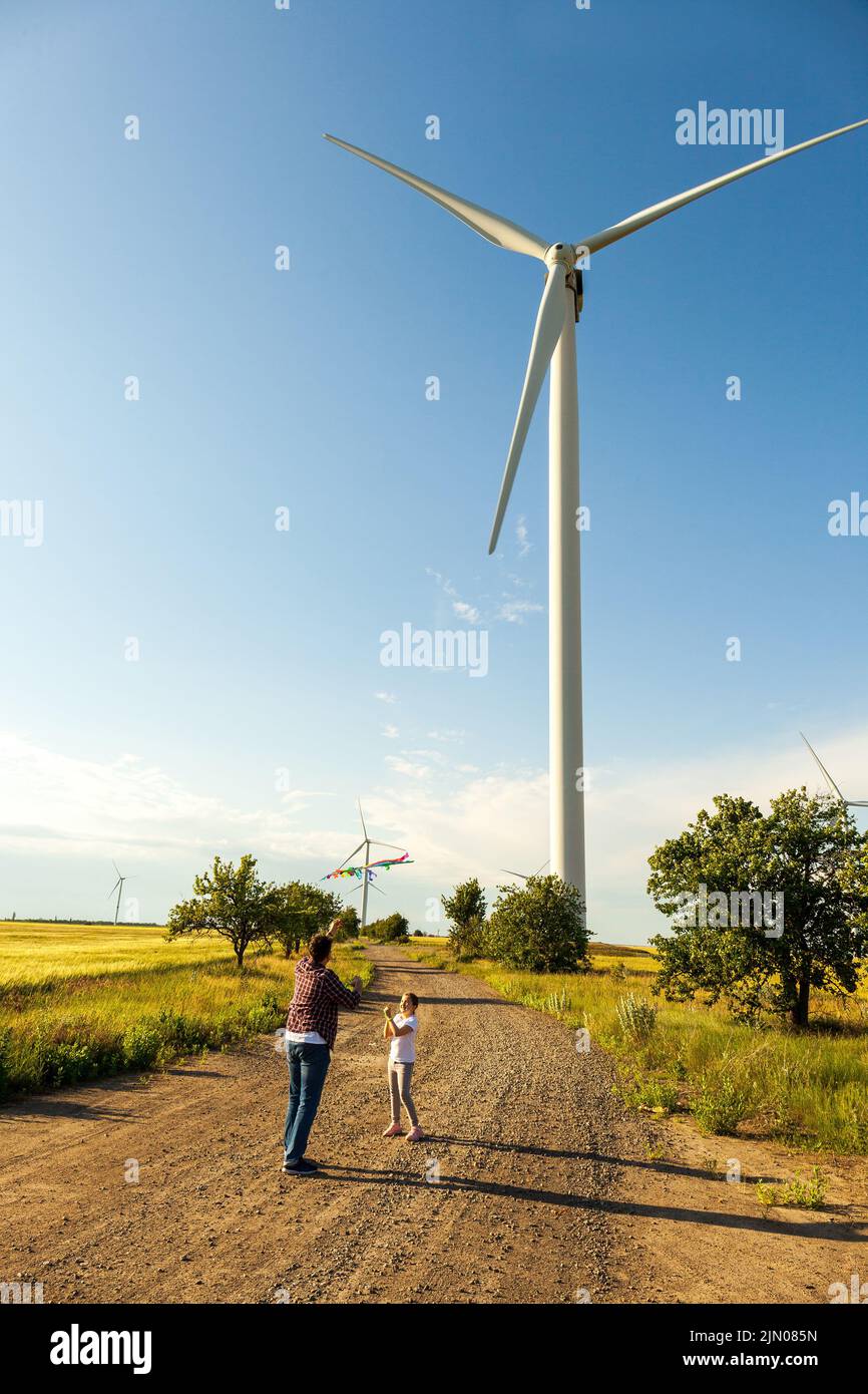 Father and daughter having fun, playing with kite together on the Wheat ...