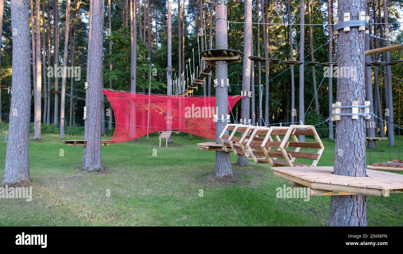Rope adventure park in the summer forest. Abstract concept Overcoming ...