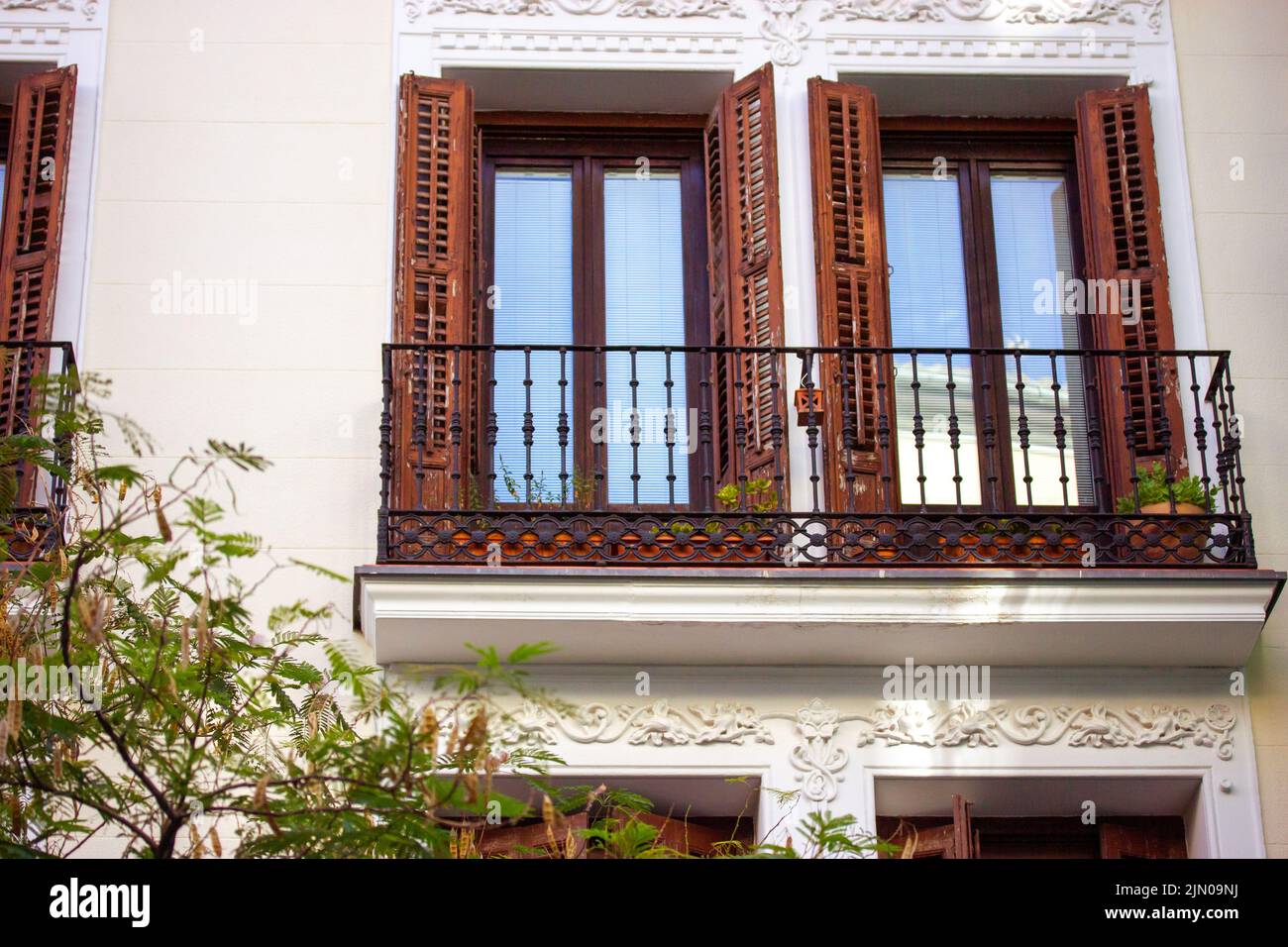 Madrid, Spain. July 3, 2022 A beautiful stucco facade of white residential house, building ...