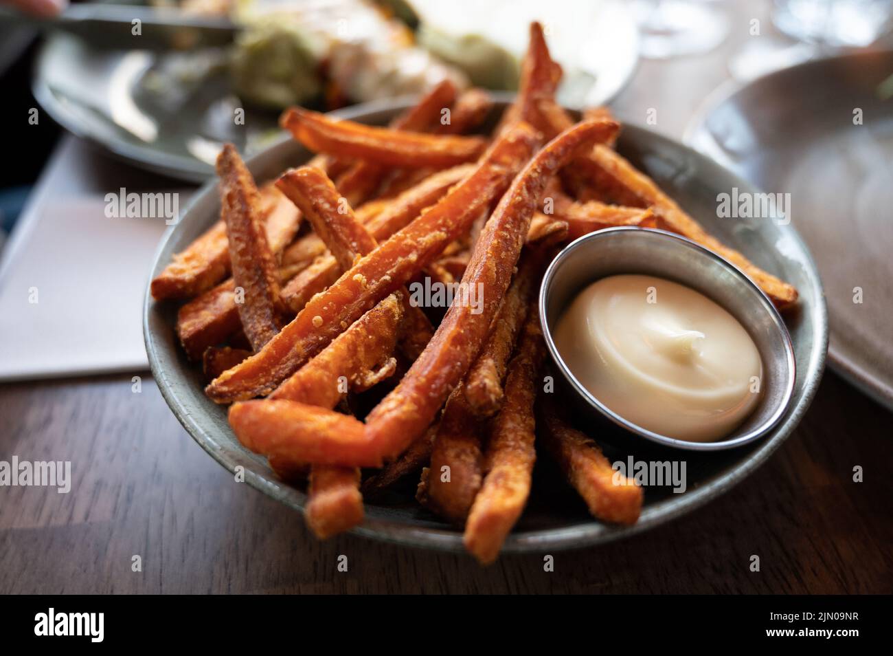 Bowl with tasty deep fried sweet potato chips served with mayonnaise ...