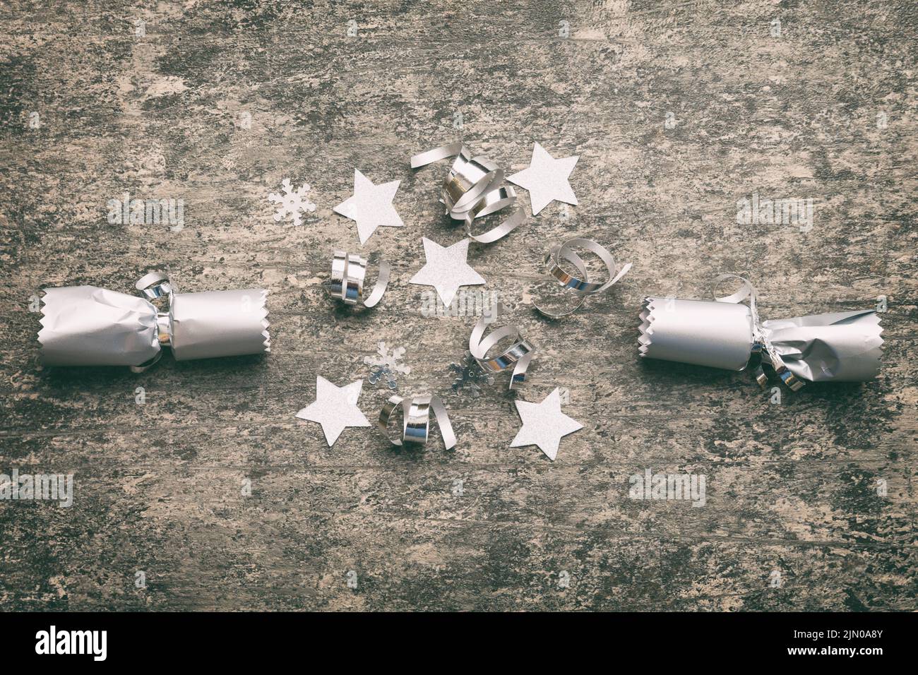 Christmas crackers with shiny confetti on color background, top view ...