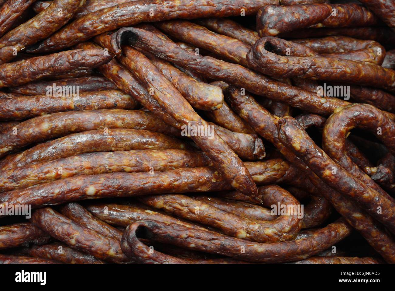 Closeup smoked sausages. Full frame. Background. a lot of sausages ...