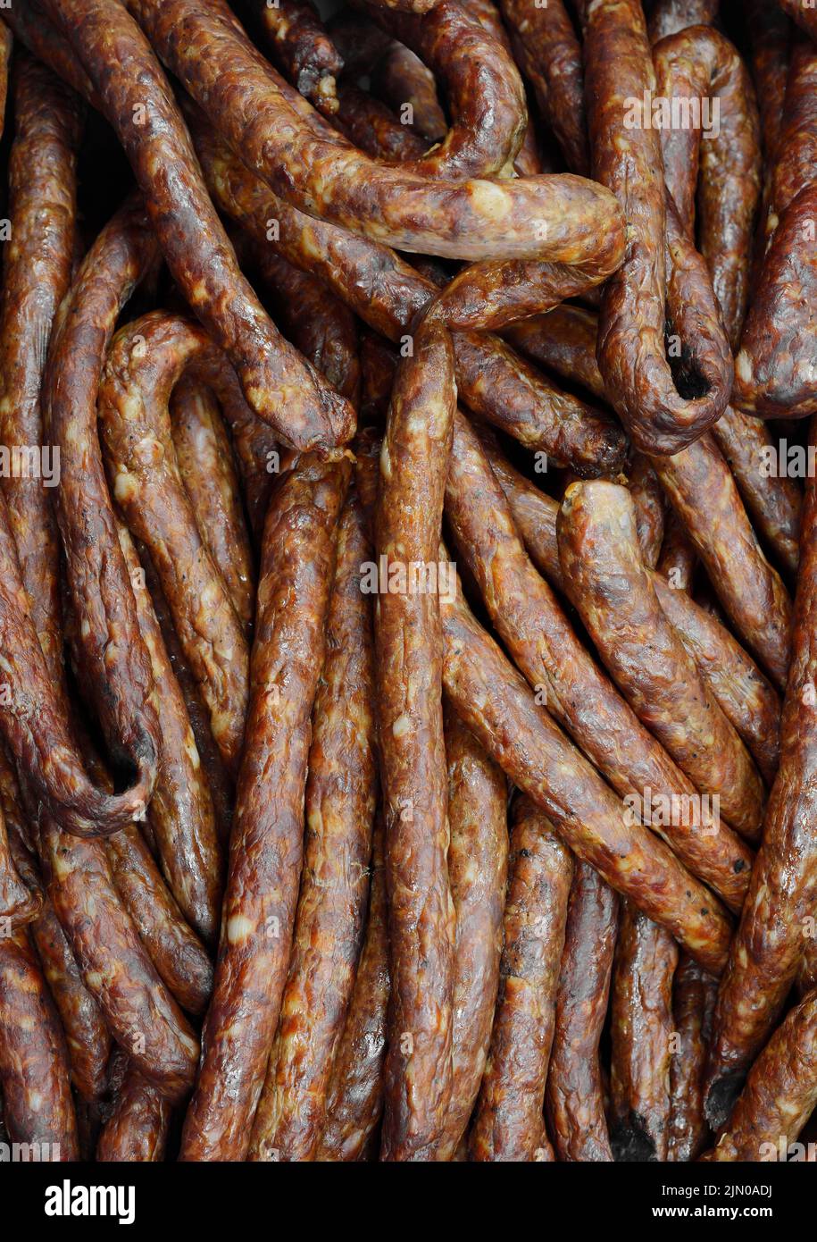 Closeup smoked sausages. Full frame. Background. a lot of sausages ...