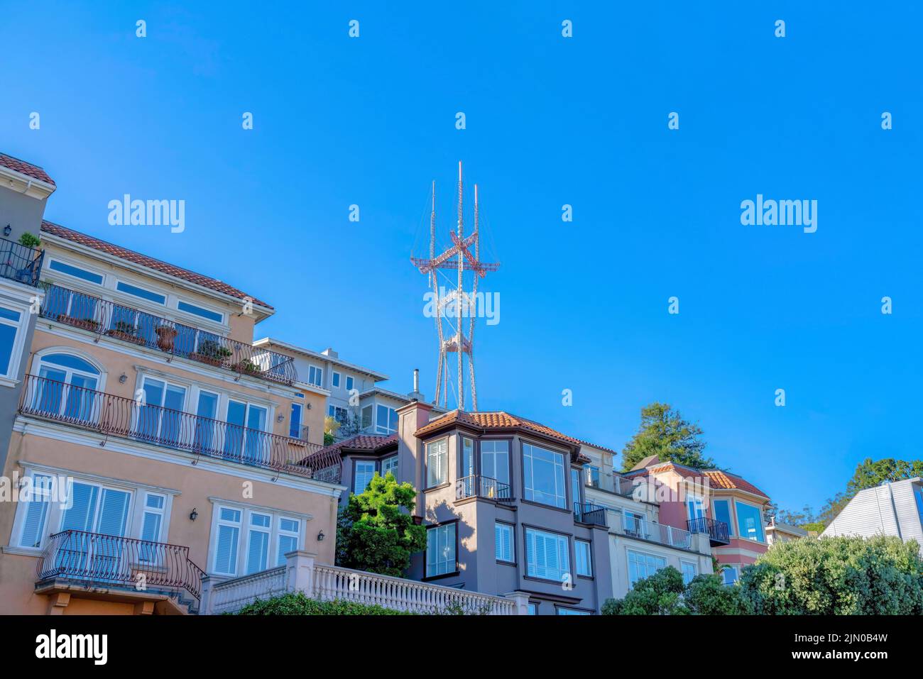 View of Sutro Tower above the large residential house buildings in San ...