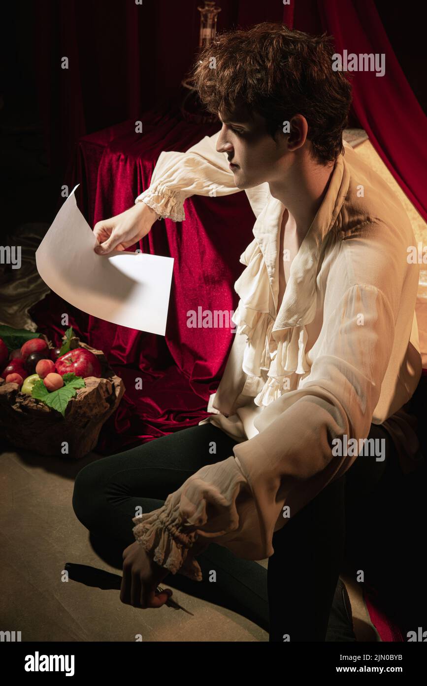 Creative portrait of young handsome man in image of famous historical ...