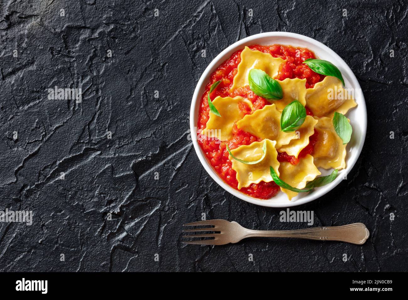 Ravioli with tomato sauce and fresh basil, Italian dumplings, top shot ...