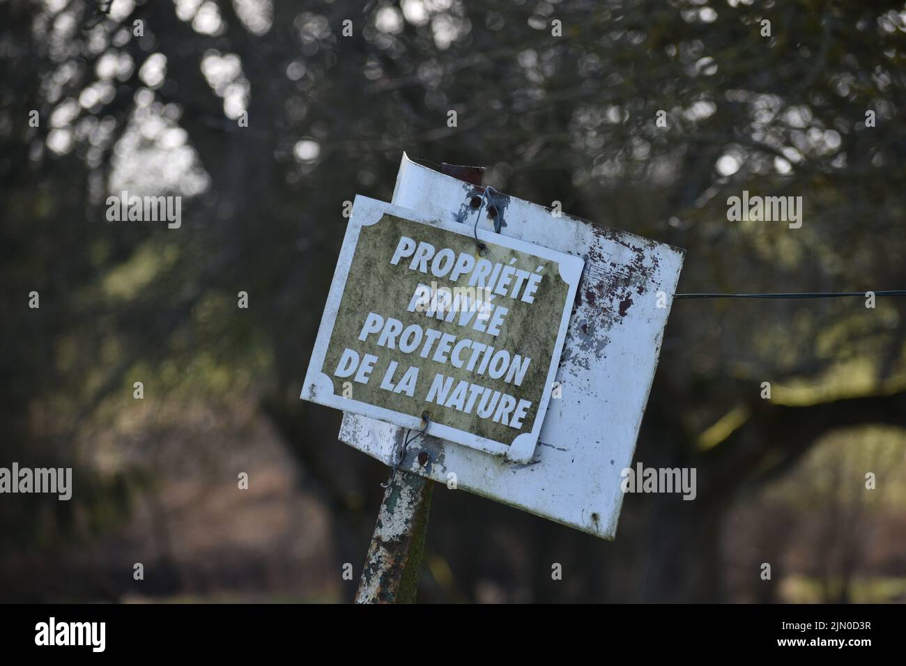 Outdoor sign with written on it in French « private property protection ...