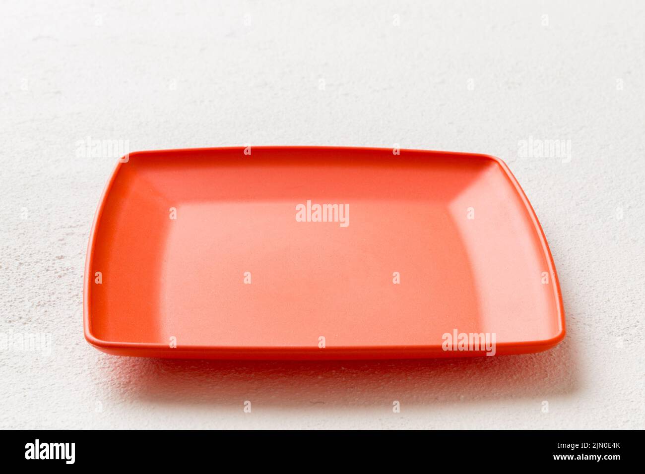 Perspective view of empty square plate on cement background. Empty ...