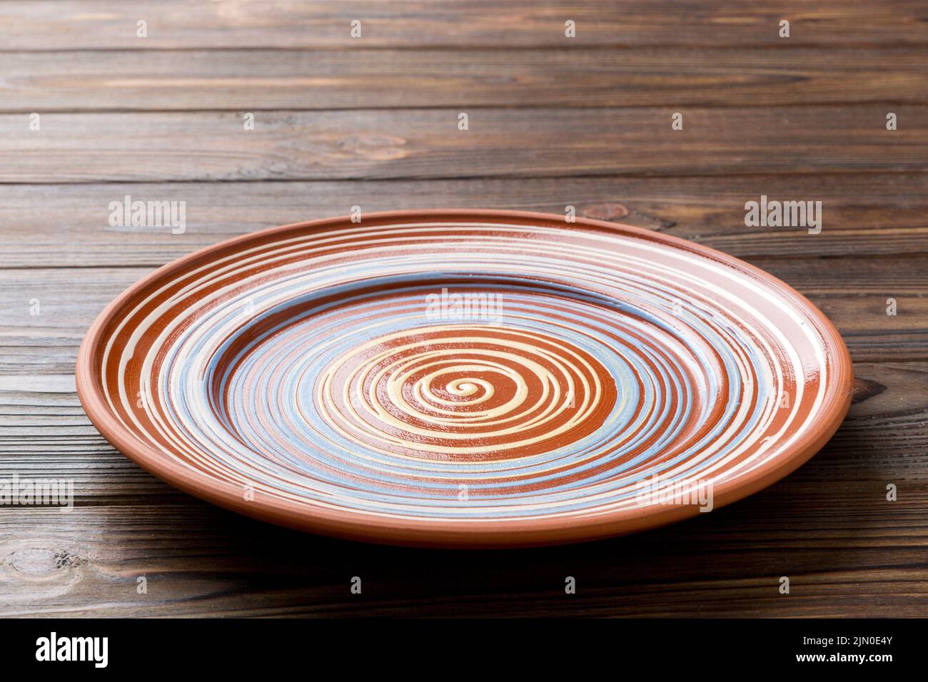 Perspective view of empty colorful plate on cement background. Empty ...