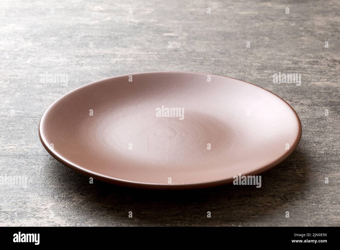 Perspective view of empty plate on cement background. Empty space for ...