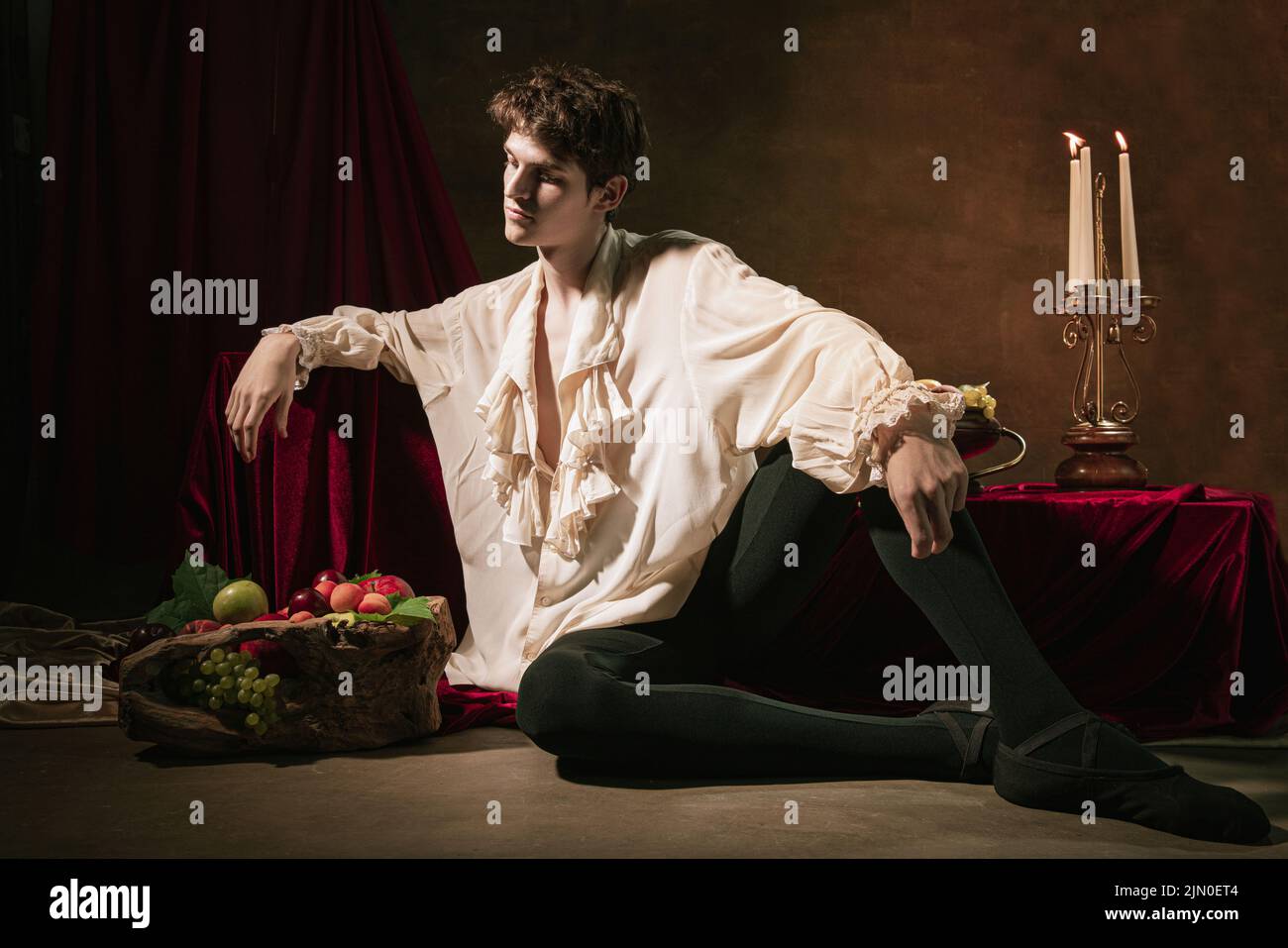 Artistic portrait of young handsome man in image of famous historical ...