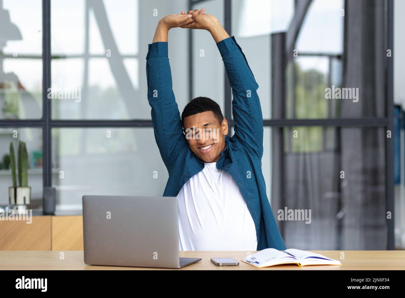 Young African American businessman man working, sitting at the ...