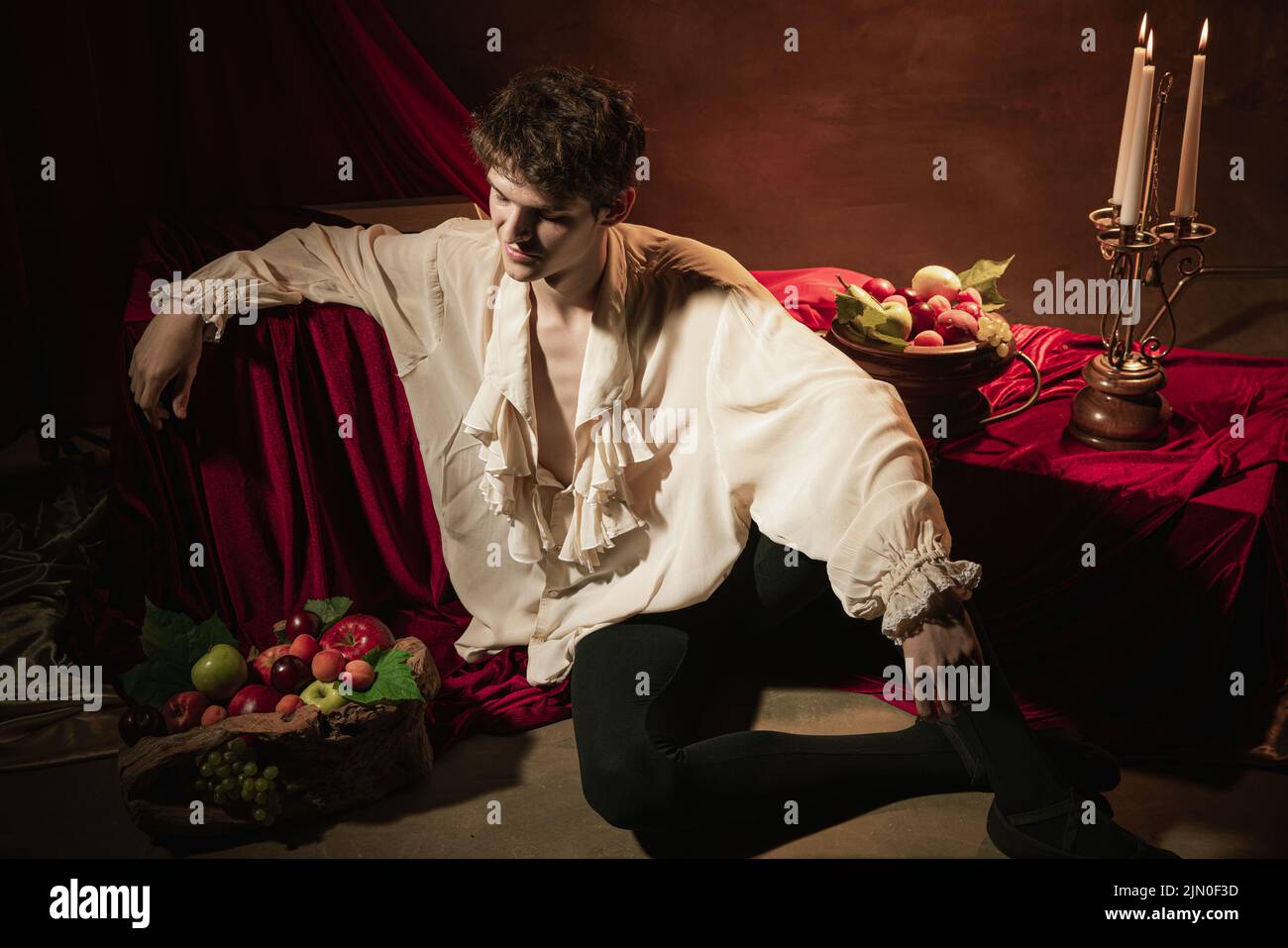 Creative portrait of young handsome man in image of famous historical ...