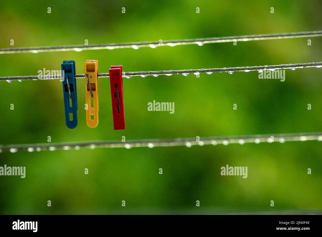 clothing lines of a clothes spin with many raindrops at the string in ...