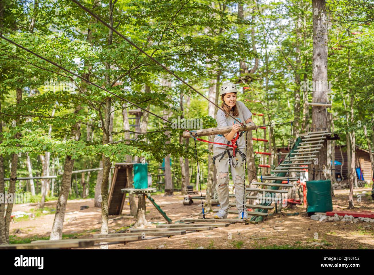 Happy women girl female gliding climbing in extreme road trolley ...