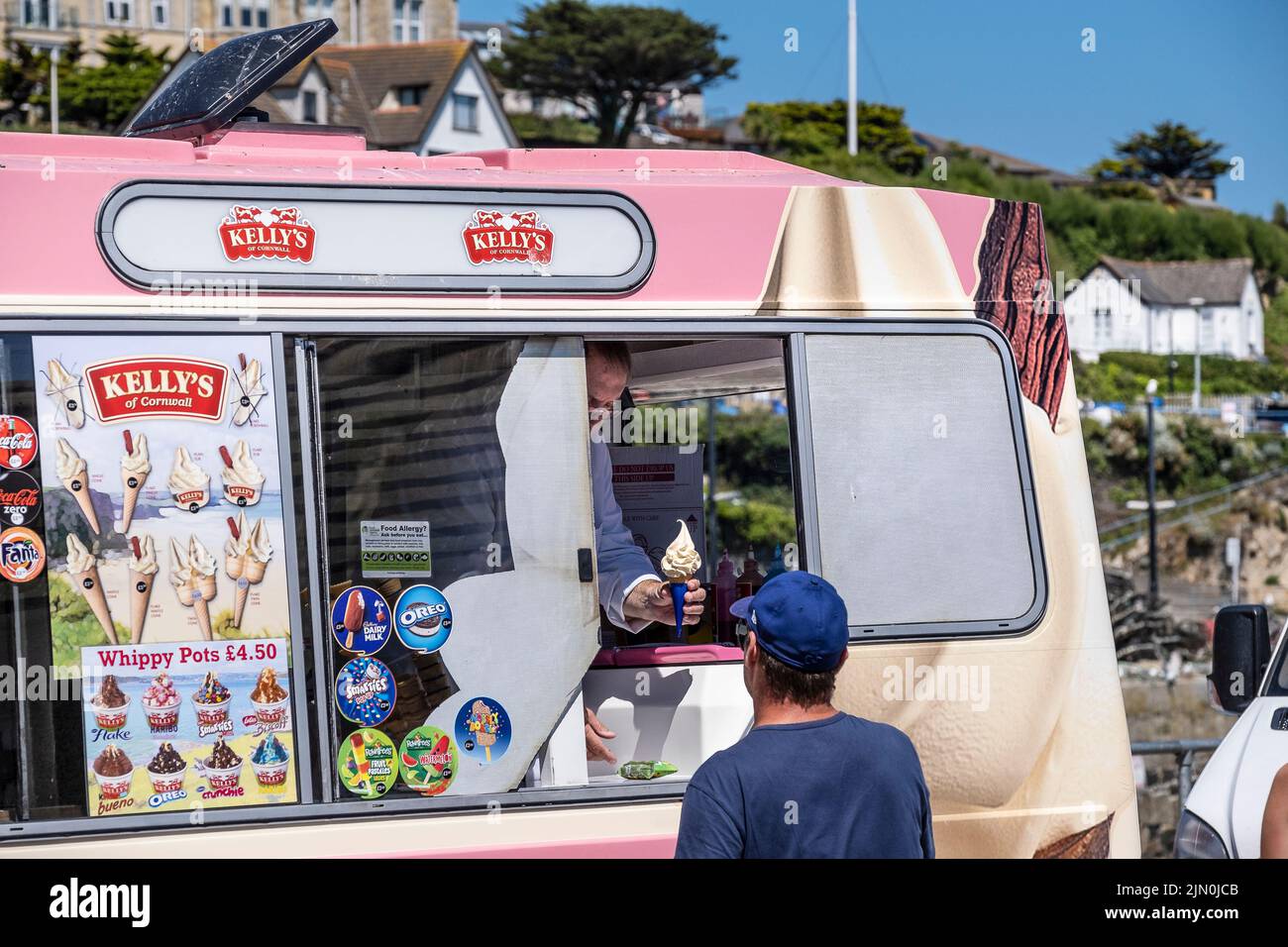A holidaymaker buying an ice cream from a Kelly's Ice Cream van in ...