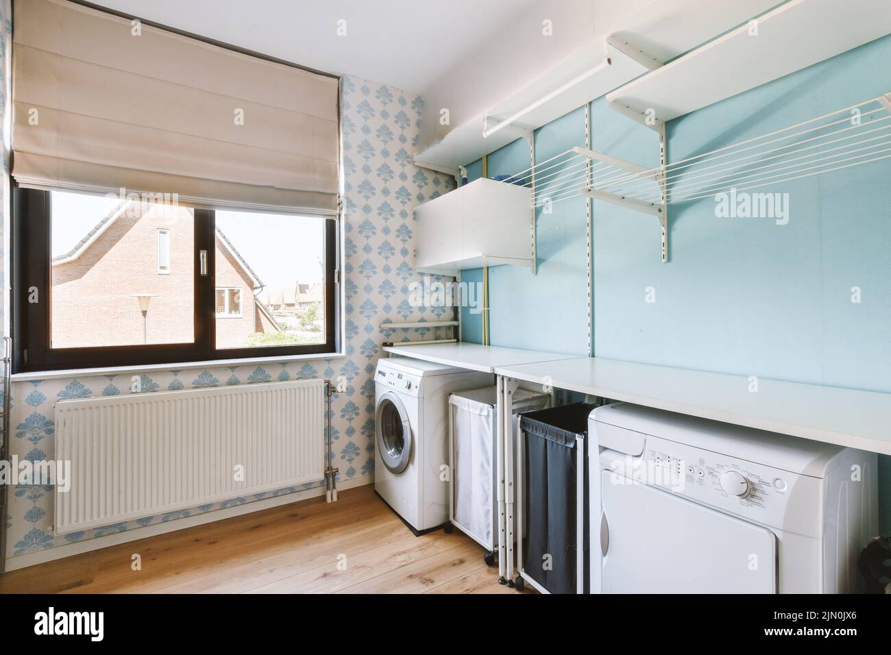 Interior of modern bright laundry room with white walls and dark ...