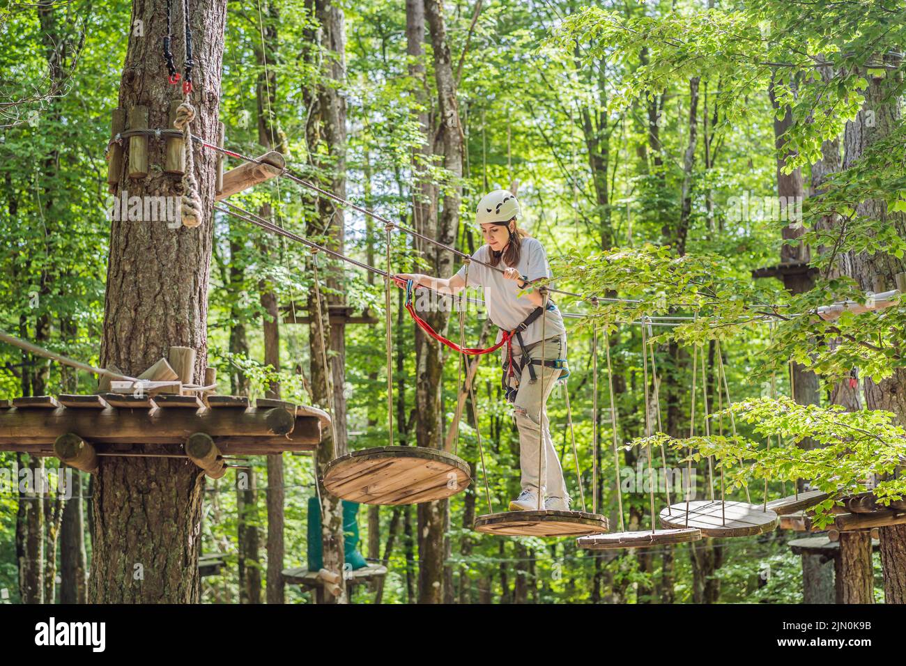 Happy women girl female gliding climbing in extreme road trolley ...