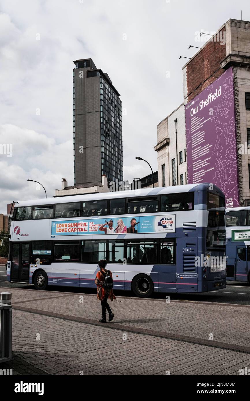 A bus and pedestrian pass in front of Sheffield Central Library and St ...