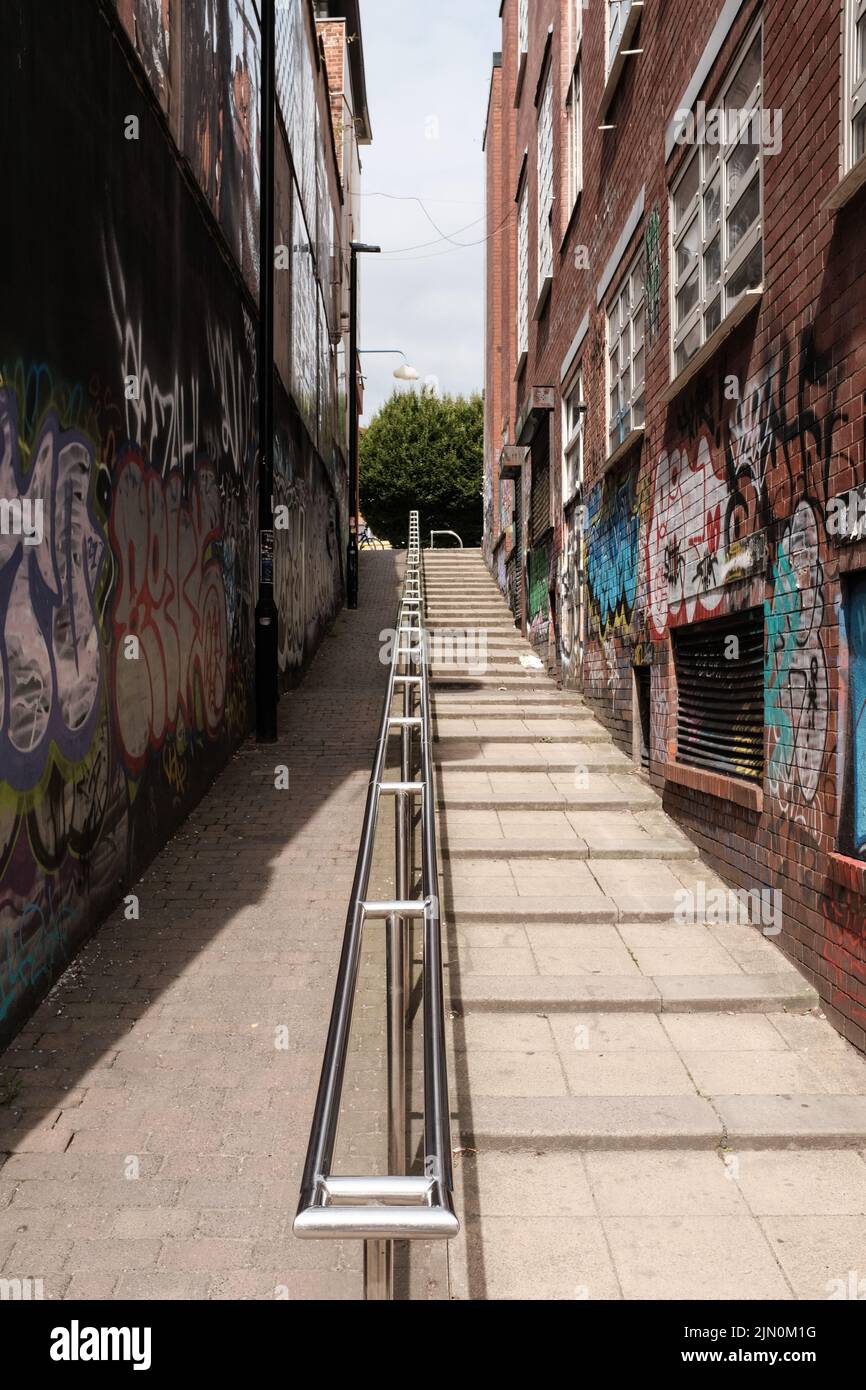 View up the steps with graffiti in the alley way of Grinders Hill in ...