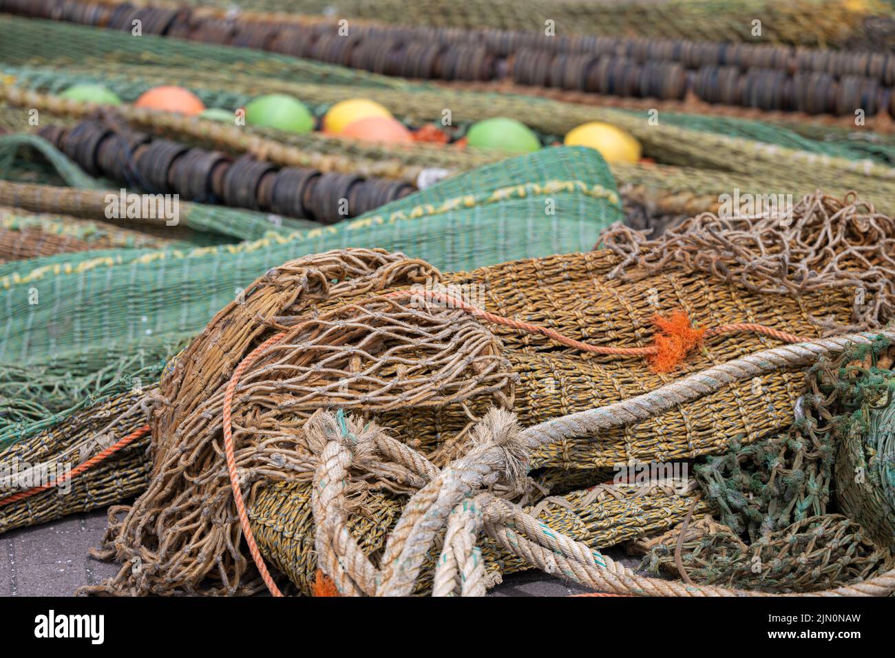 Colored nets and ropes on a quay of a Dutch harbour Stock Photo - Alamy