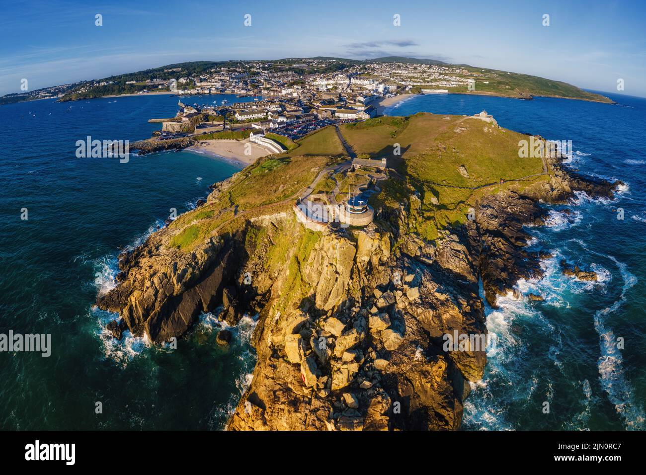 The aerial view of the rocky shore and town surrounded by sea. St Ives ...