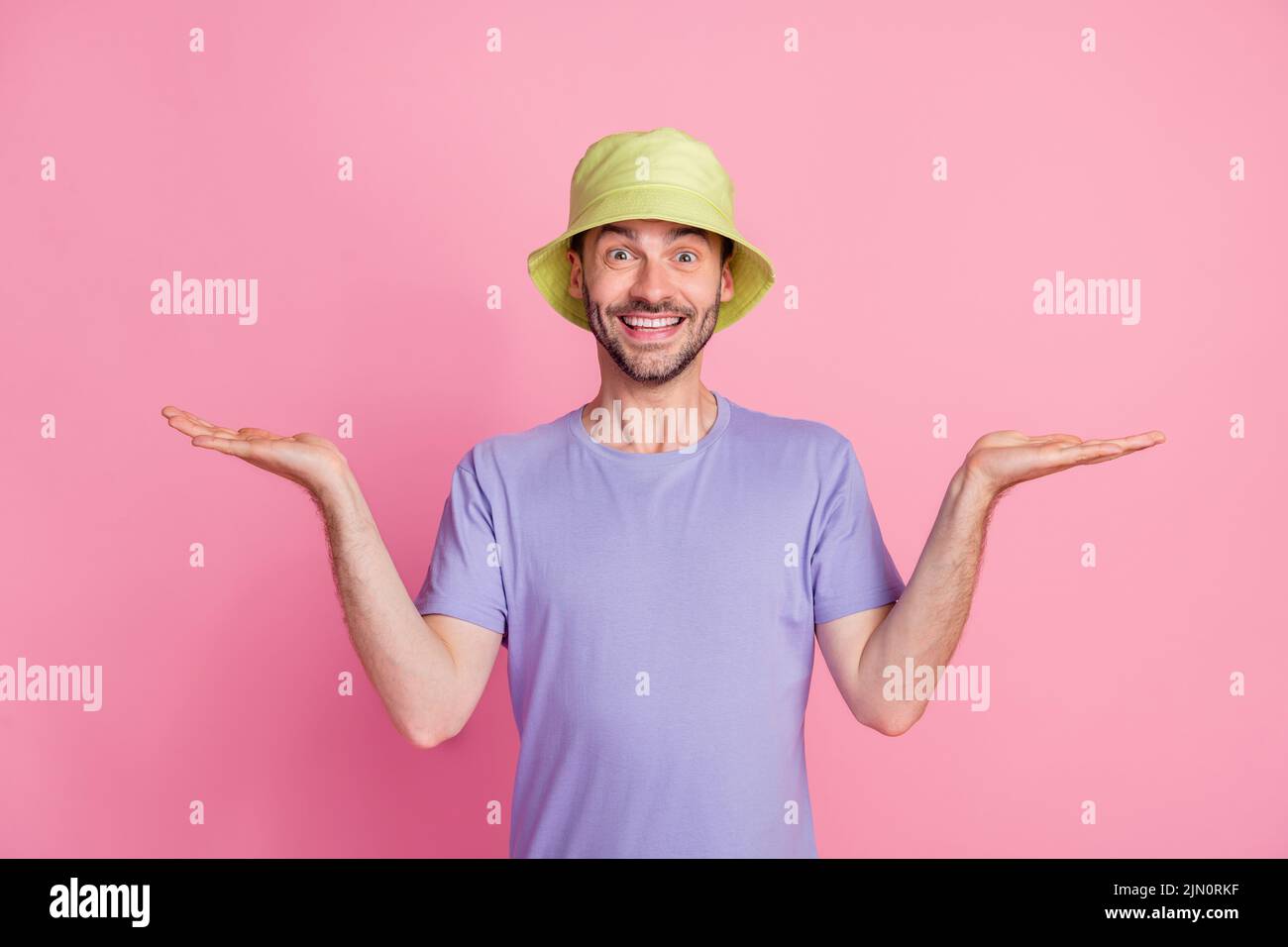Portrait of cheerful positive nice dude boy arms present empty space vs ...