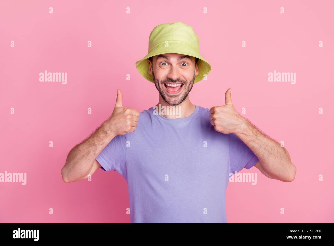 Photo of joyful cool guy trendy outfit good mood raise arms up show ...