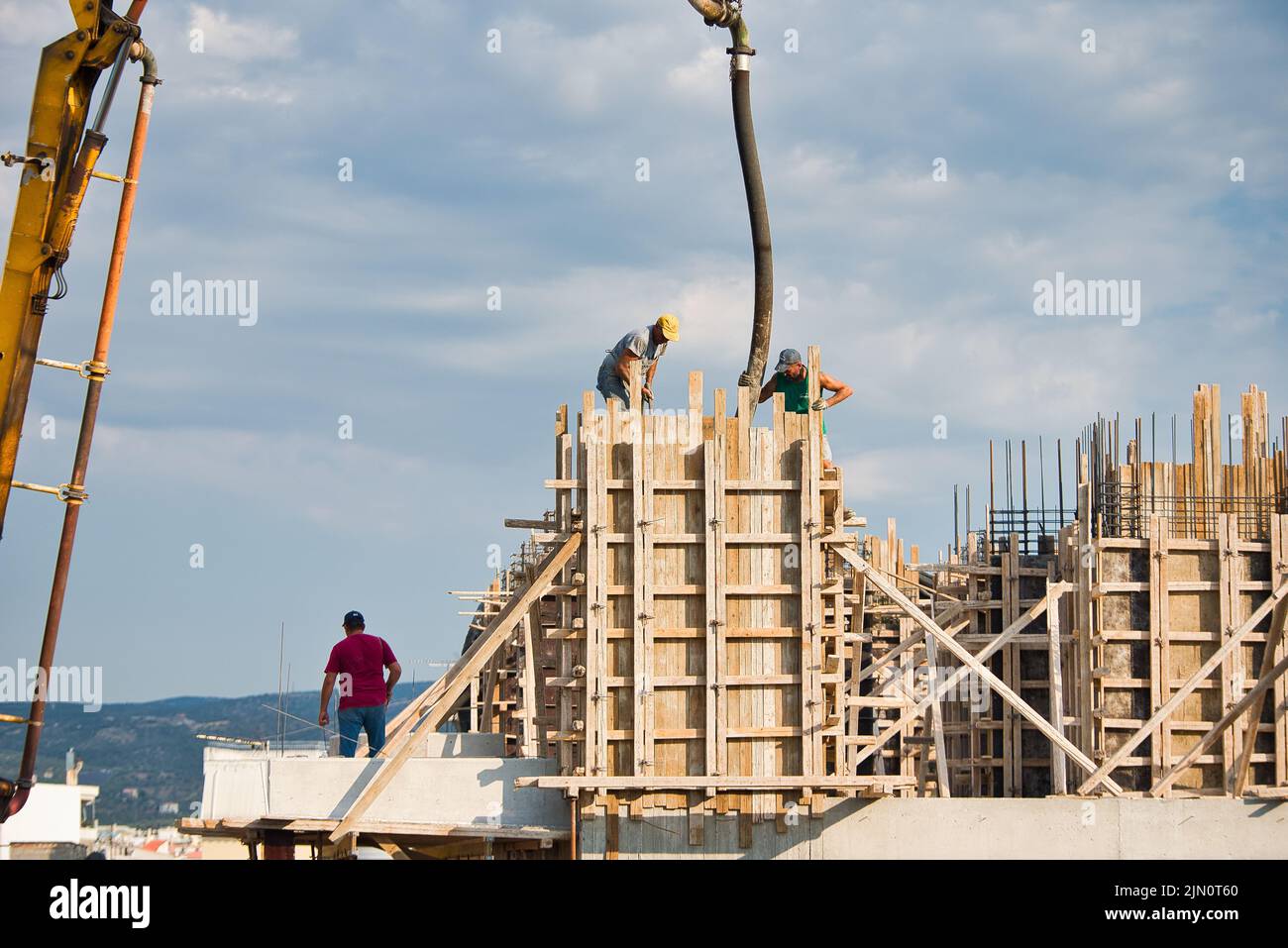 building an apartment building, construction workers are working hard ...