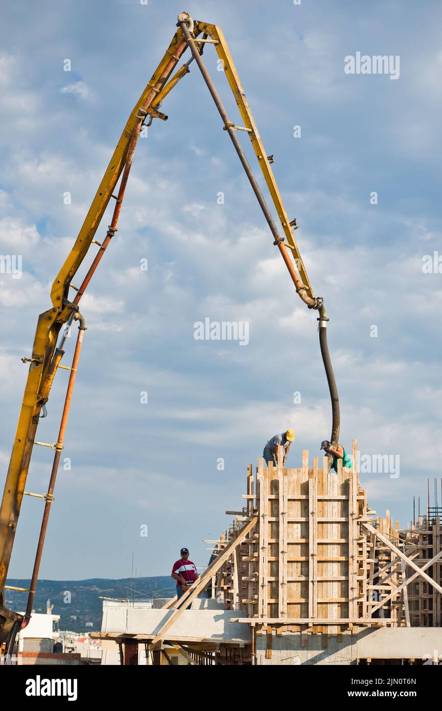 building an apartment building, construction workers are working hard ...