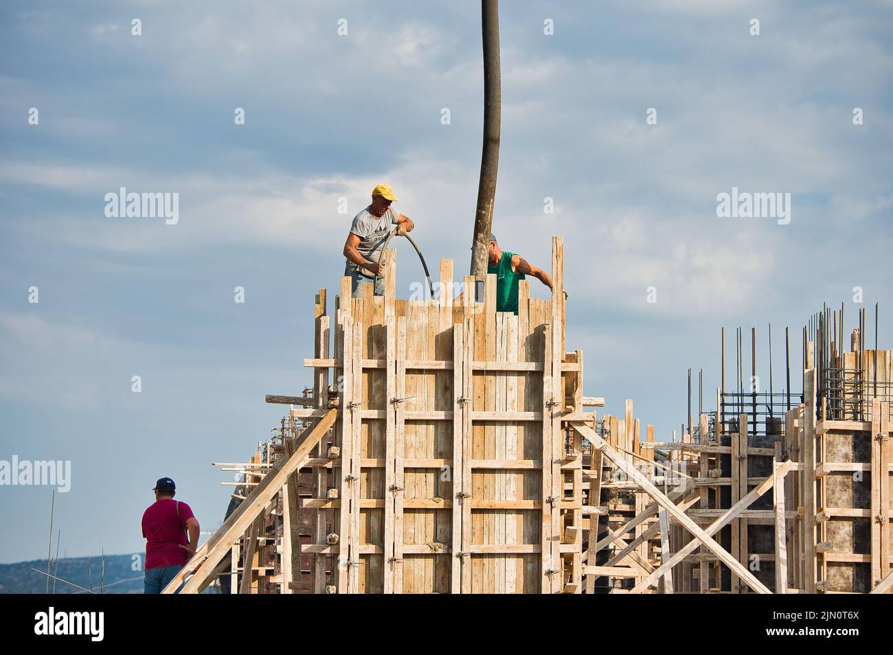 building an apartment building, construction workers are working hard ...